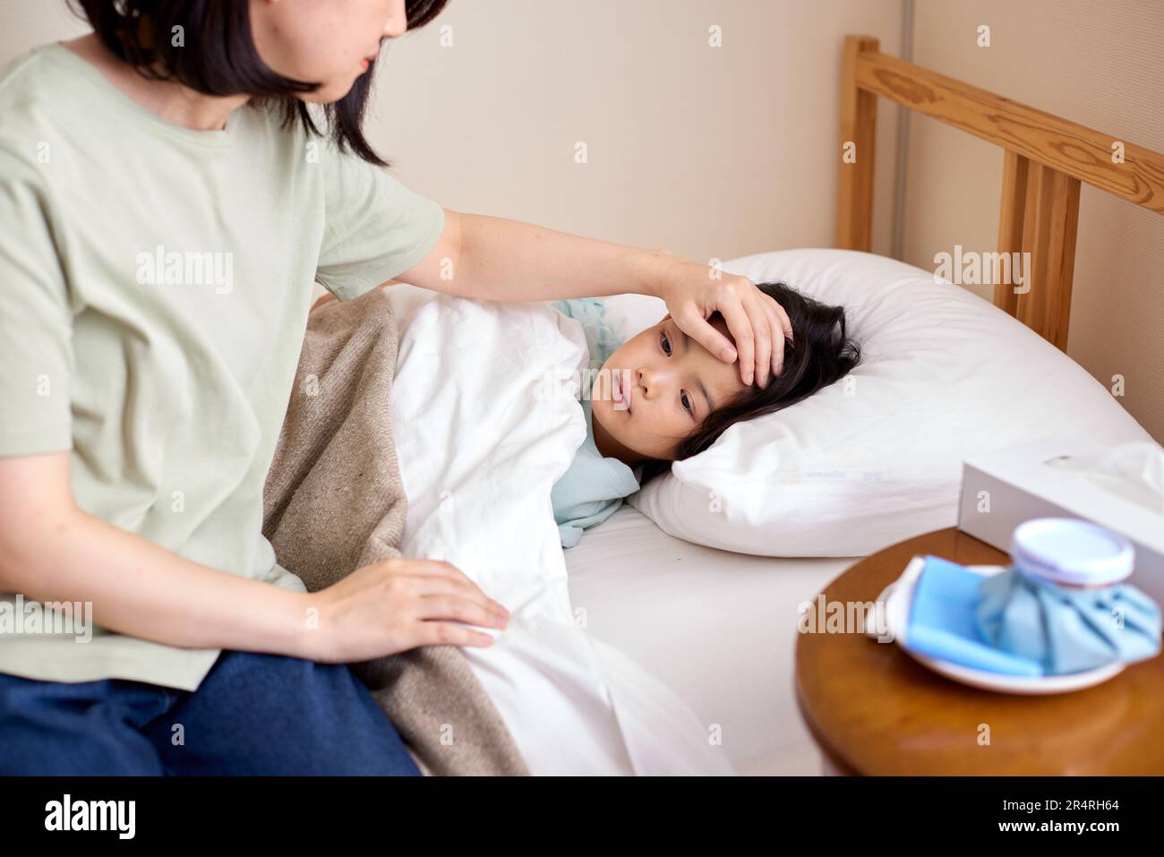 Japanese kid sick in bed Stock Photo - Alamy