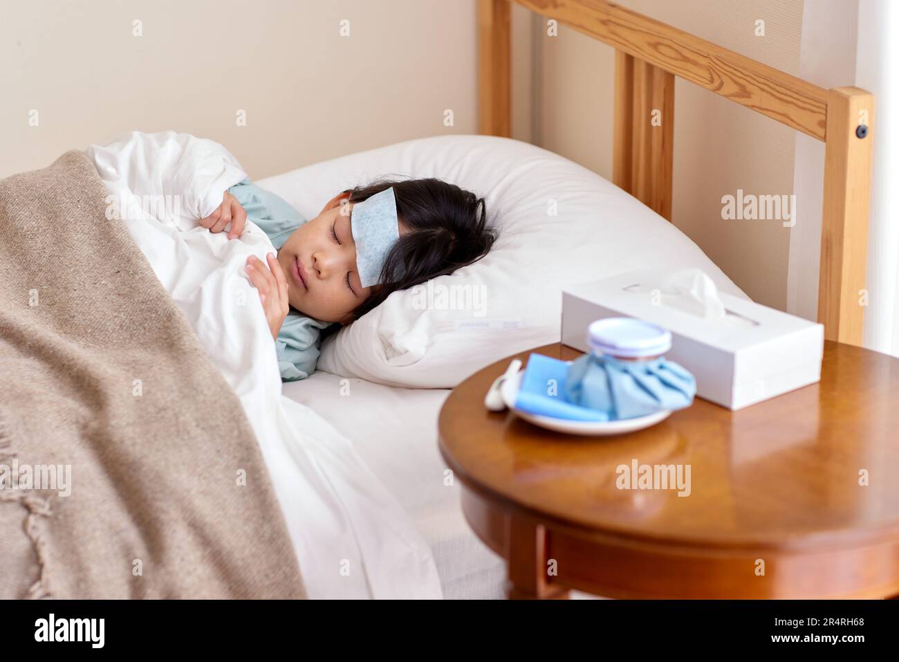 Japanese kid sick in bed Stock Photo - Alamy