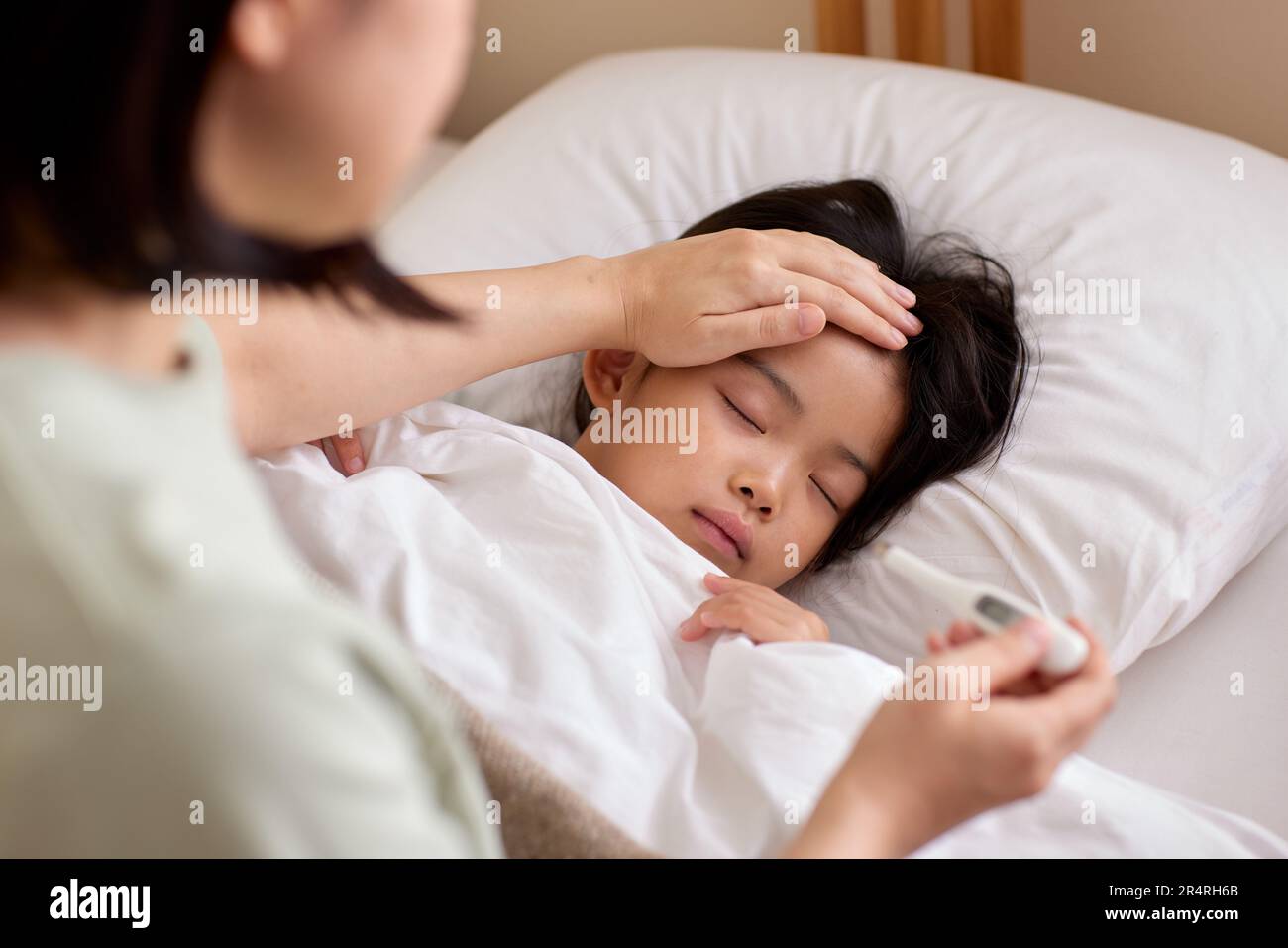 Japanese kid sick in bed Stock Photo - Alamy