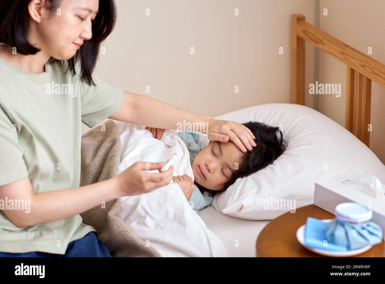 Japanese kid sick in bed Stock Photo - Alamy