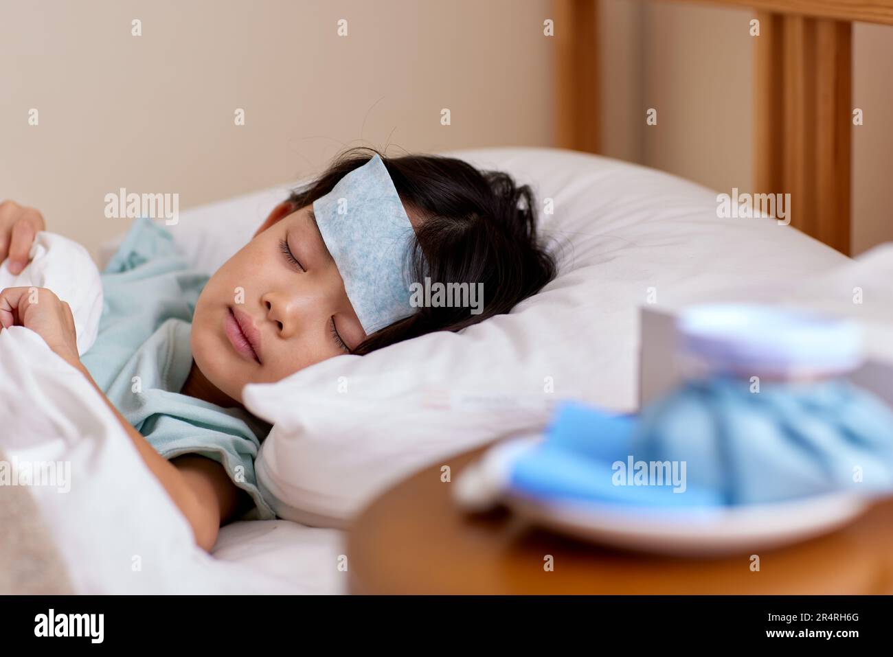 Japanese kid sick in bed Stock Photo - Alamy