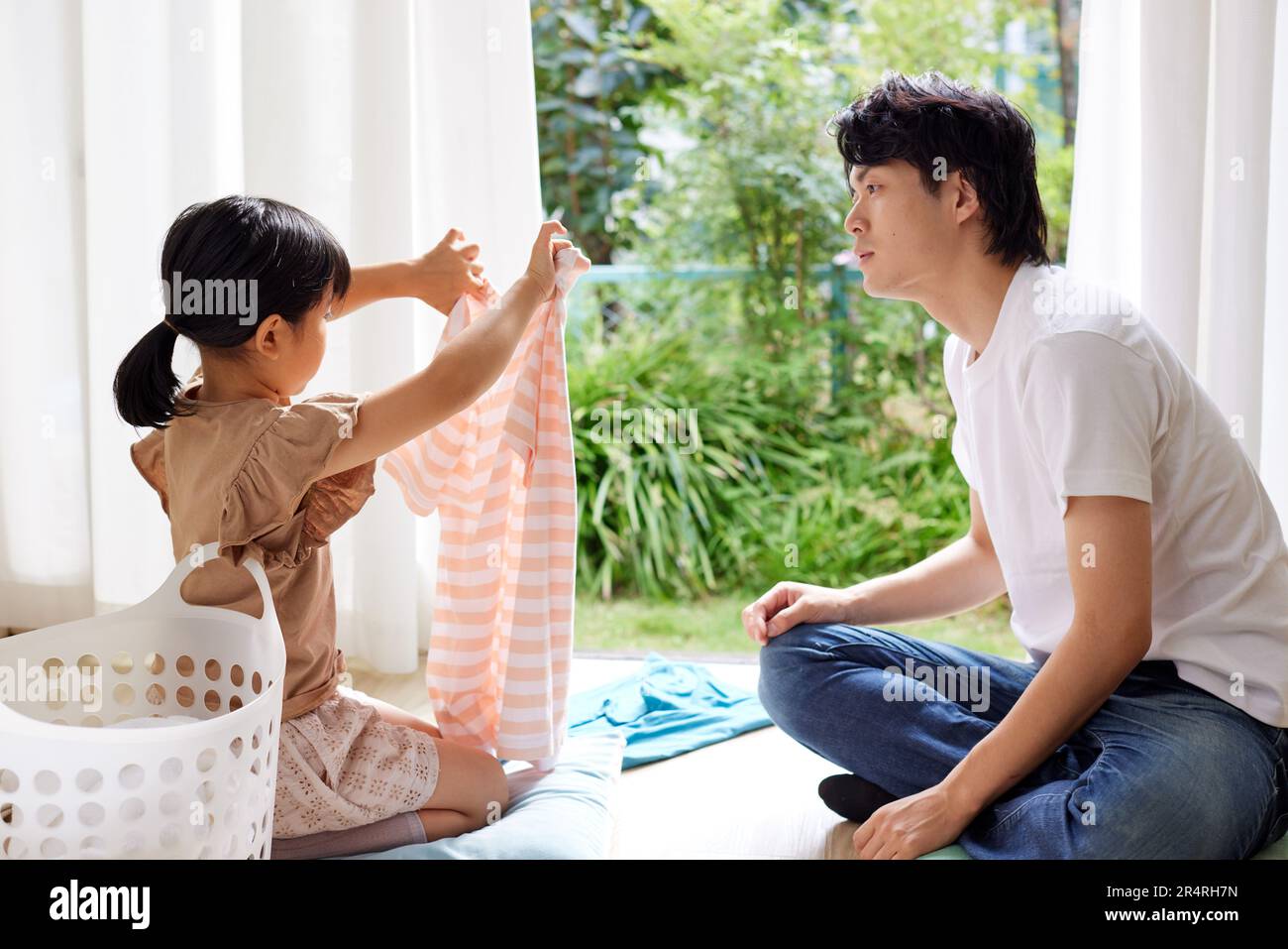 Japanese kid folding clothes Stock Photo - Alamy