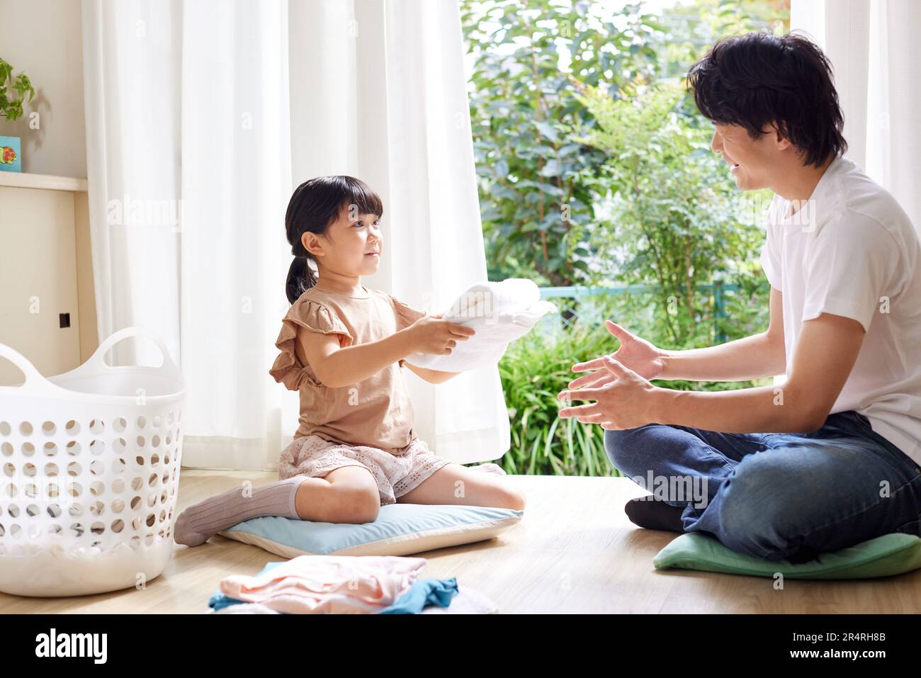Japanese kid folding clothes Stock Photo - Alamy