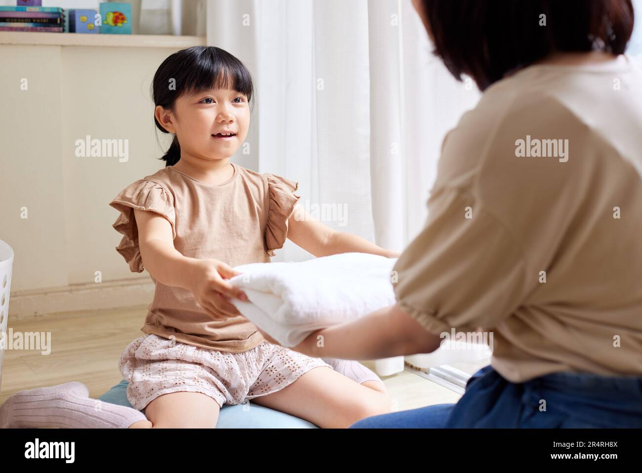 Japanese kid folding clothes Stock Photo - Alamy