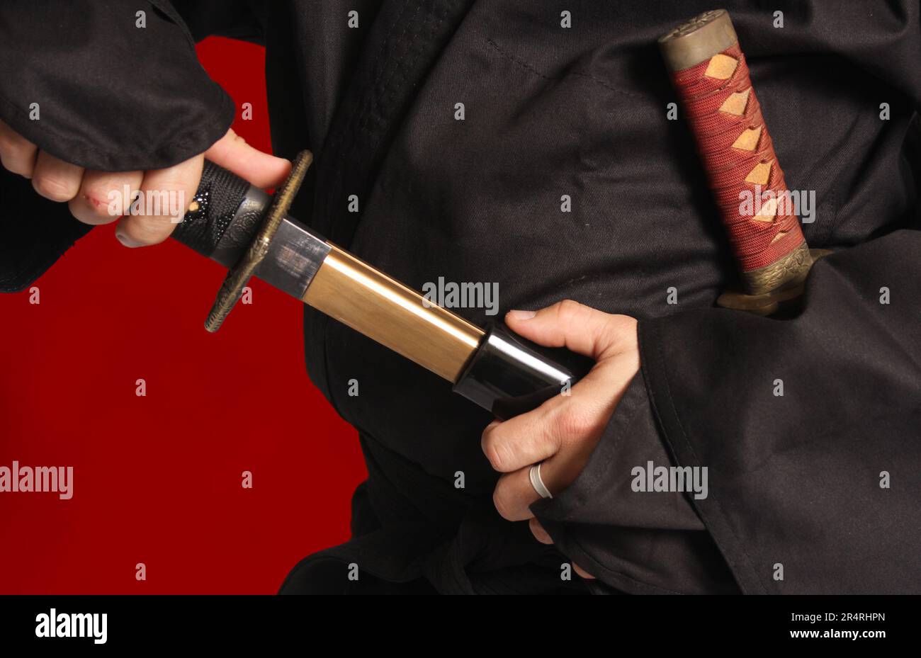 Man Removing Japanese Katana Sword From Scabbard Stock Photo - Alamy