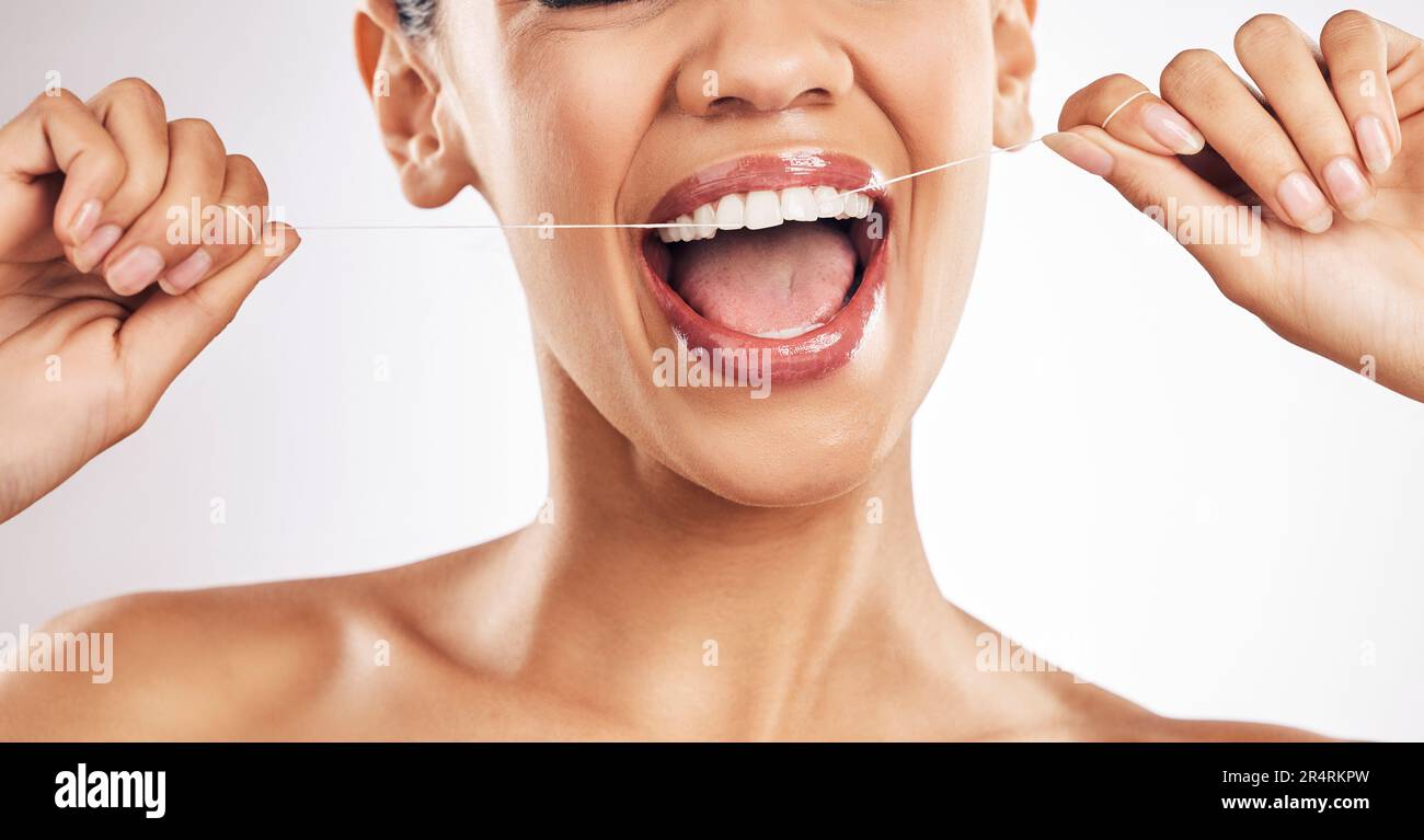 Smile, dental and woman flossing teeth in studio for hygiene, wellness ...
