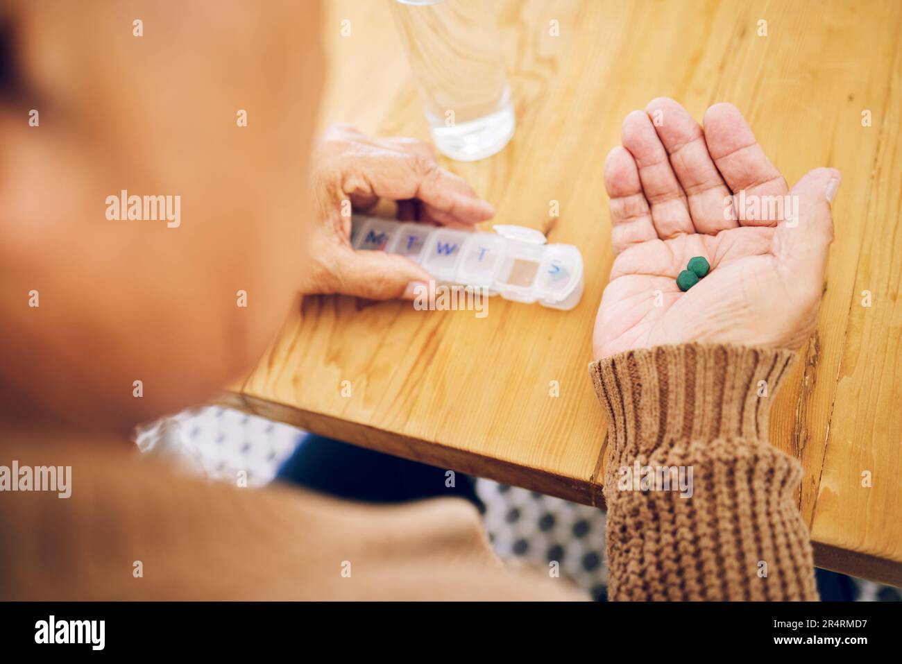 Senior person, hand and pill box for daily medication, health and ...