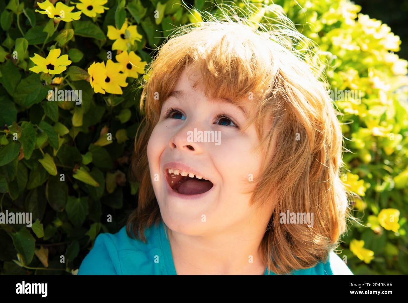 Spring excited surprised boy on blooming tree. Smiling kid outdoor ...