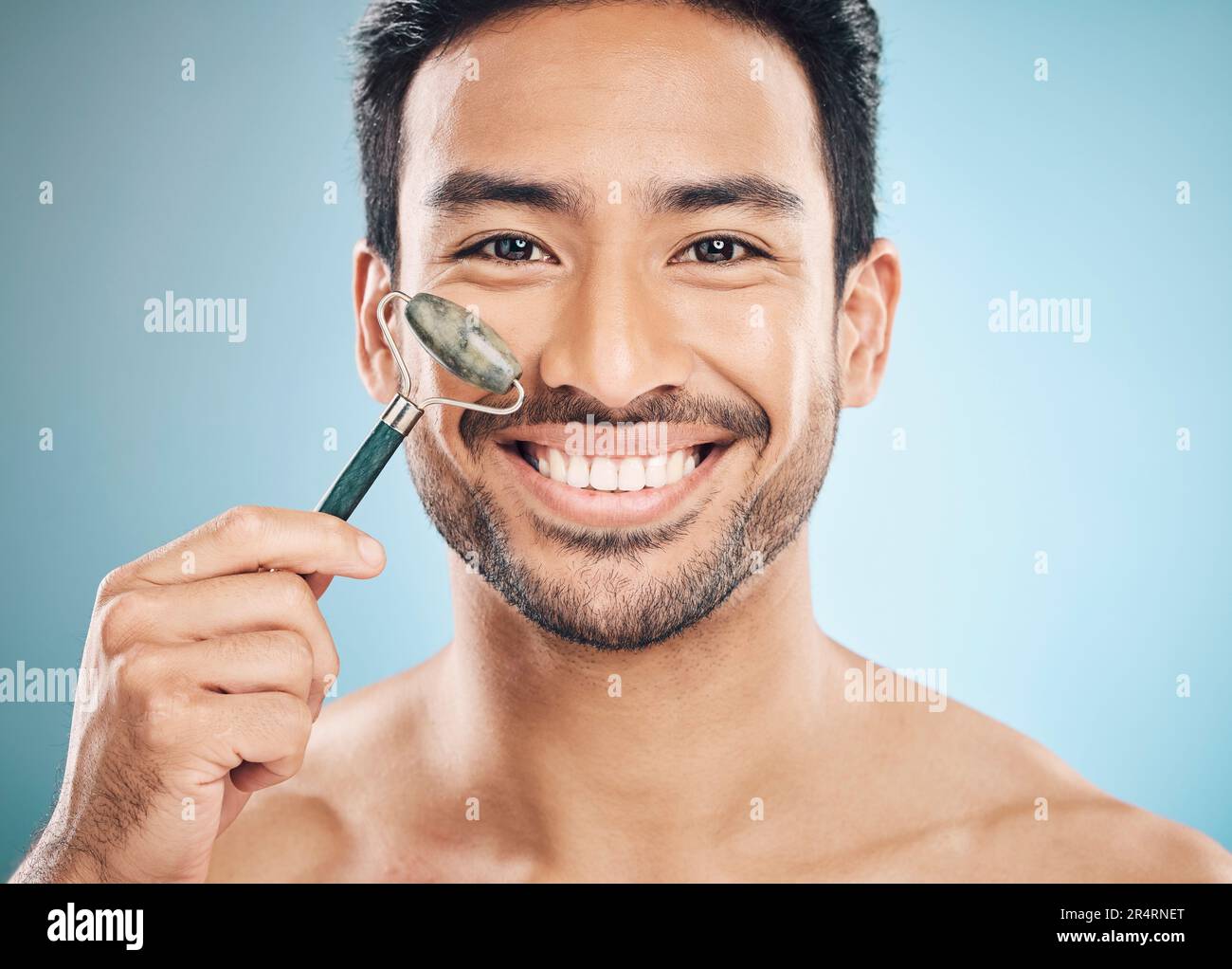 Beauty, portrait or happy man with jade roller, facial product for soft ...