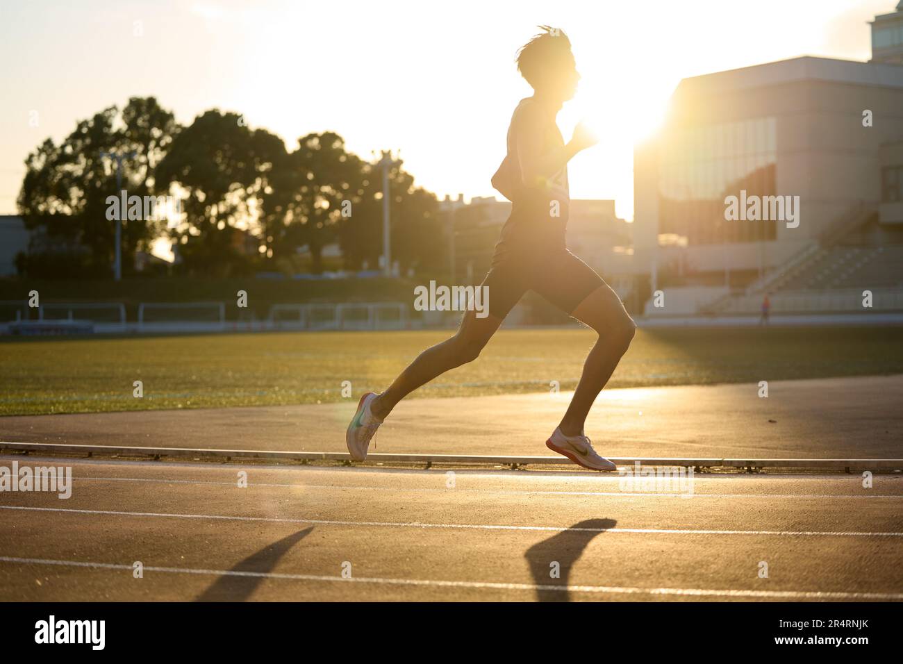Japanese athletes running on track Stock Photo - Alamy