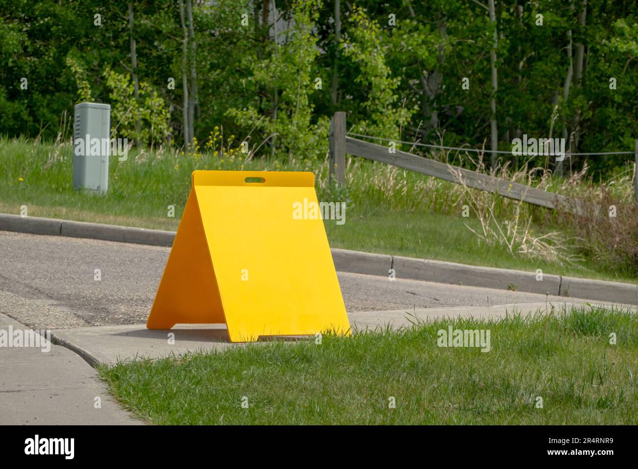 Side view to a yellow double sided floor stand sign Stock Photo - Alamy