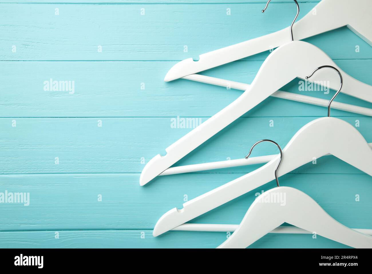 Many wooden white hangers on grey background. Store concept, empty ...