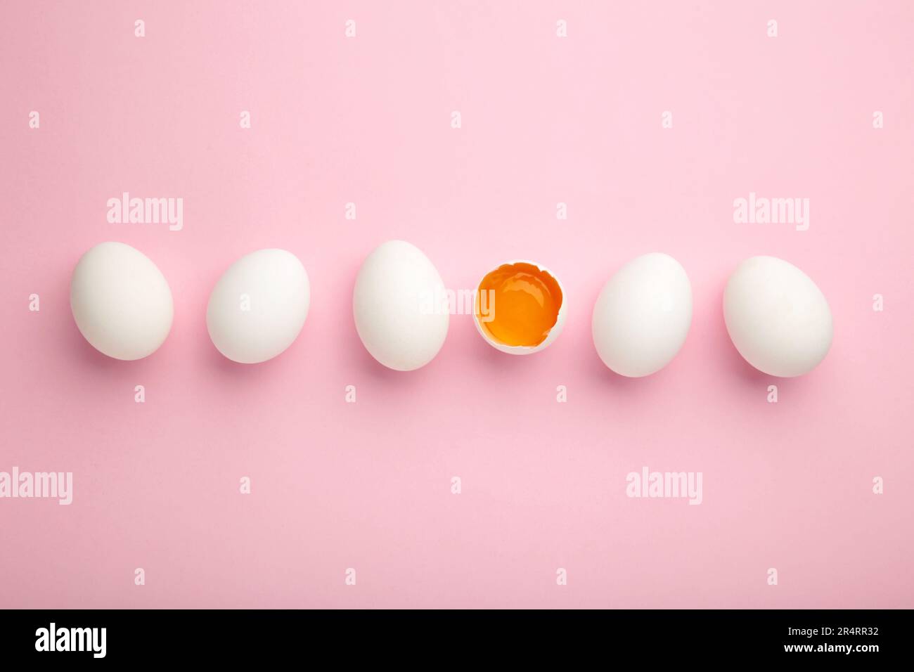 White eggs and egg yolk on the pink background. Spring Stock Photo - Alamy
