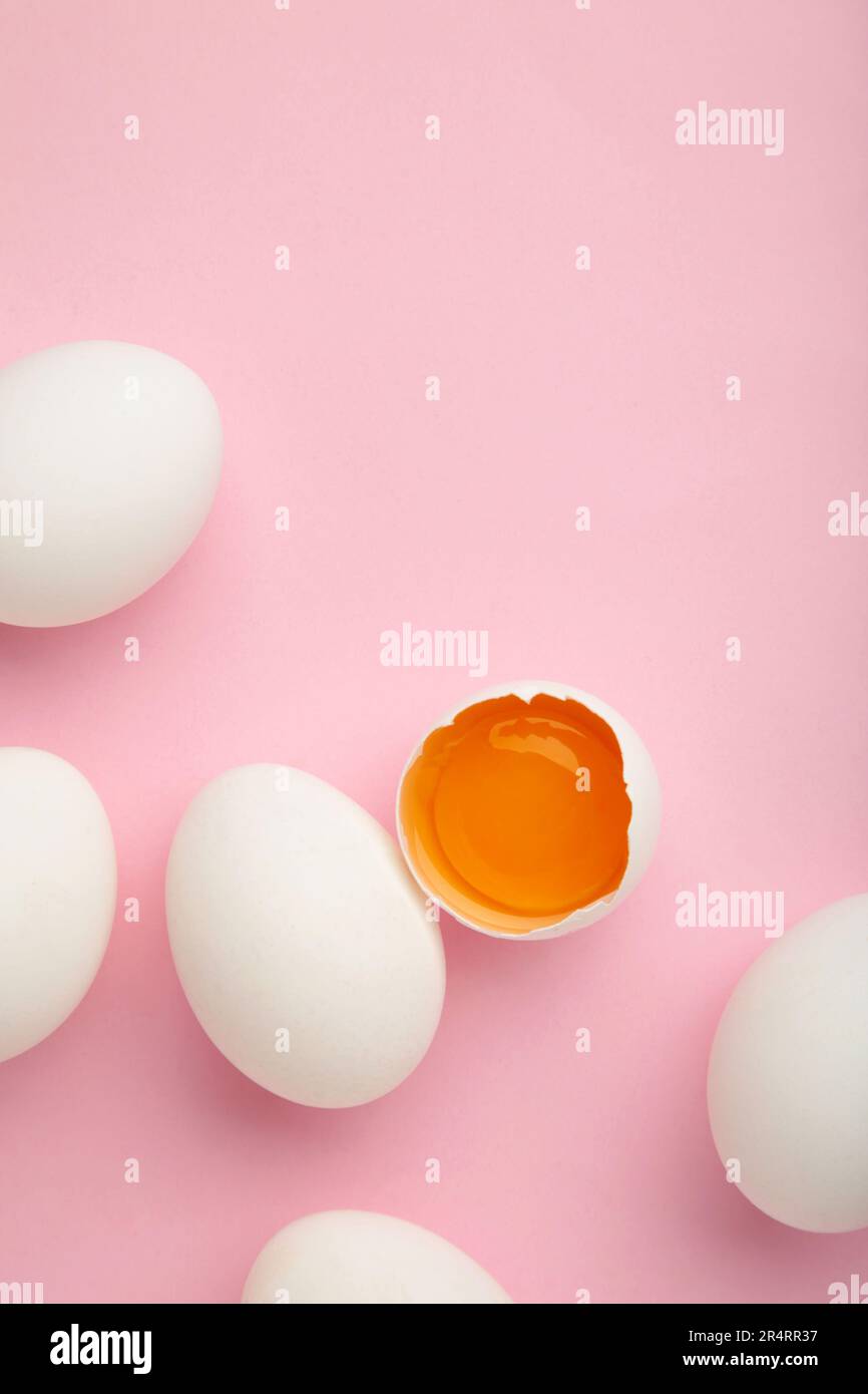 White eggs and egg yolk on the pink background. Spring Stock Photo - Alamy