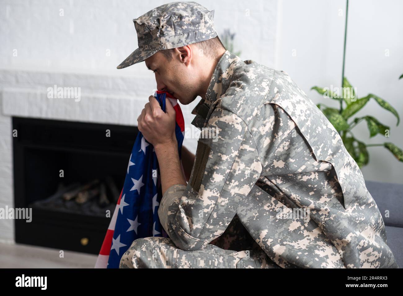 upset American soldier holding flag of United States while crying ...