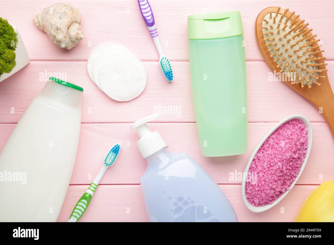 Bath products on pink background. Shower gel with aromatic salt, soap ...