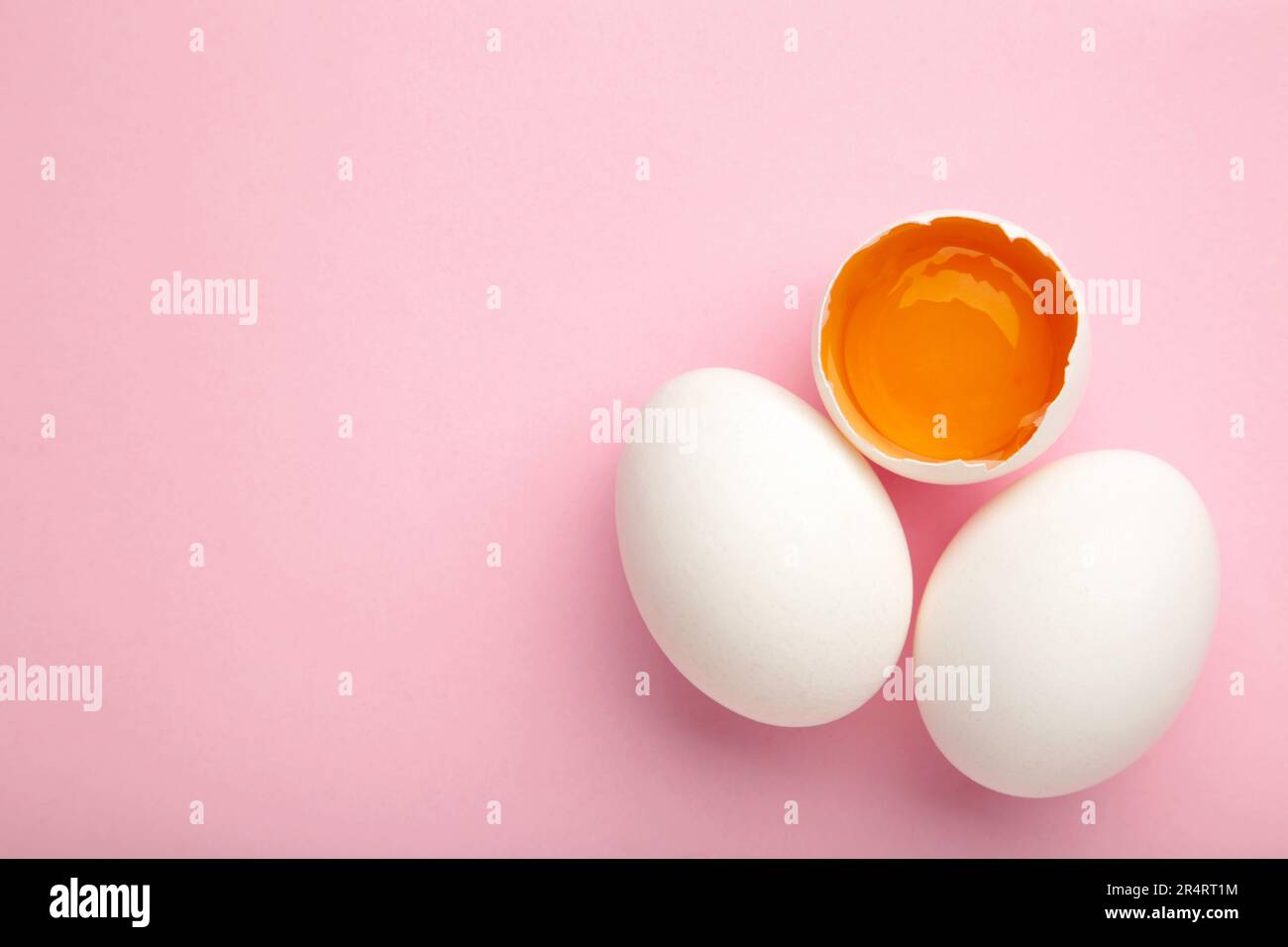 White eggs and egg yolk on the pink background. Spring Stock Photo - Alamy