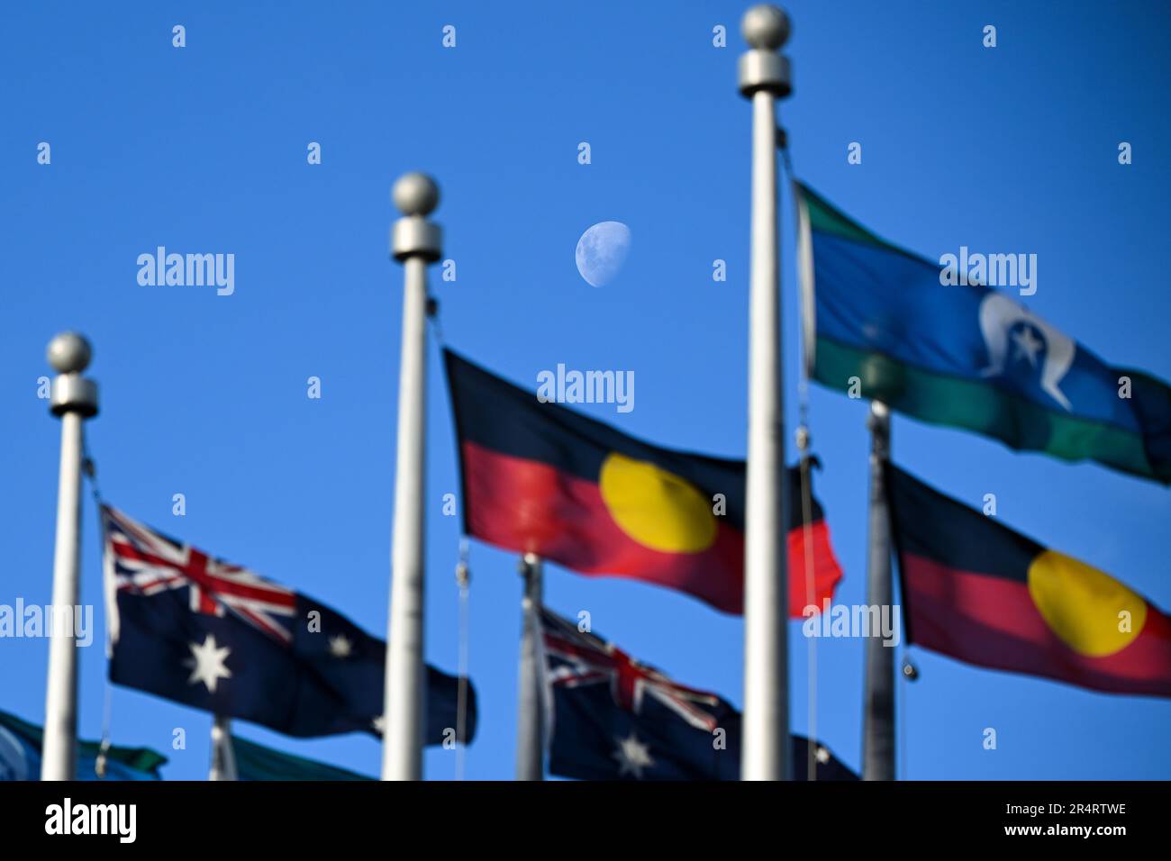 Canberra, Australia. 30th May, 2023. The moon is seen behind the ...