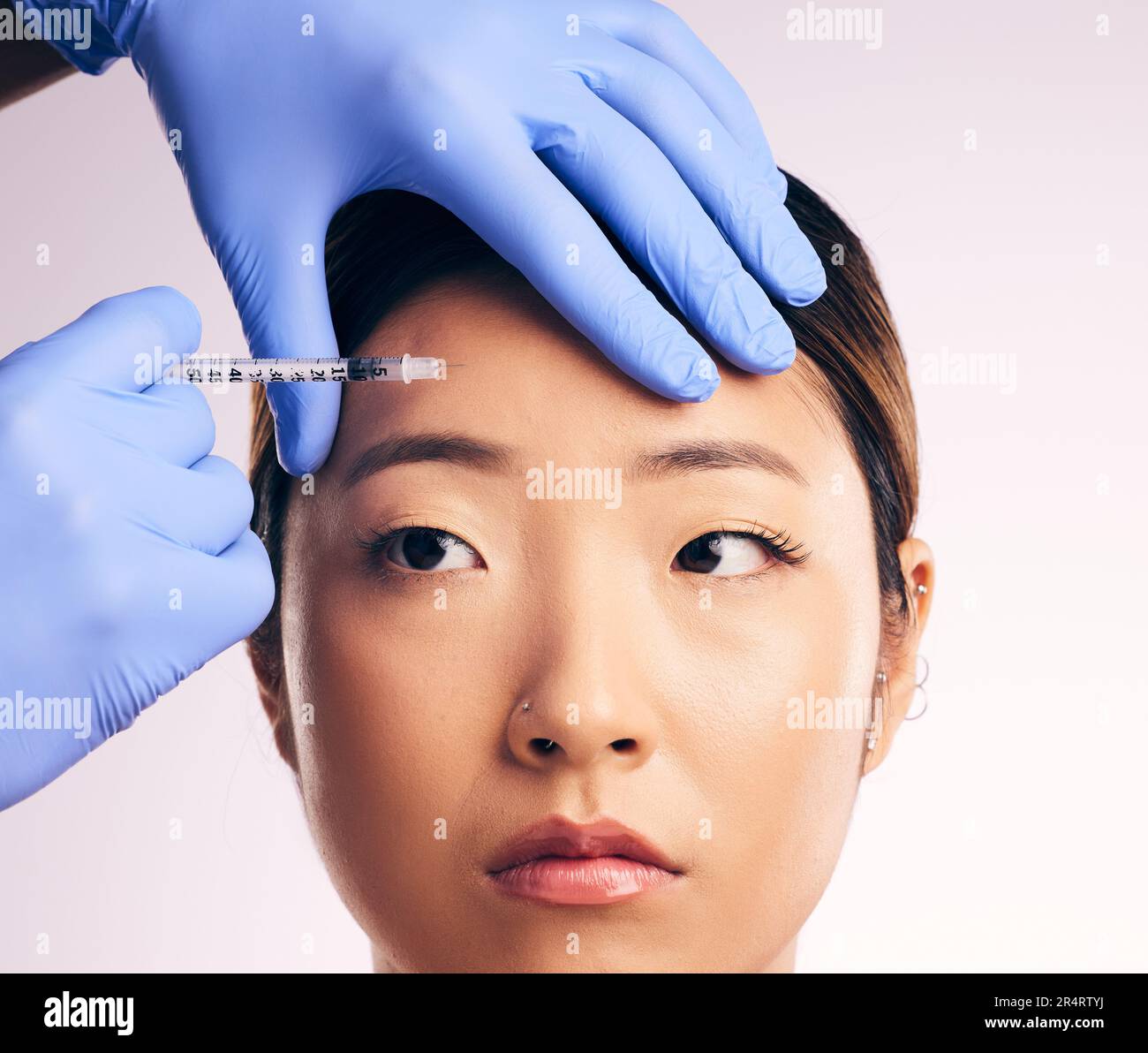 Forehead injection, face skincare and Asian woman in studio isolated on ...