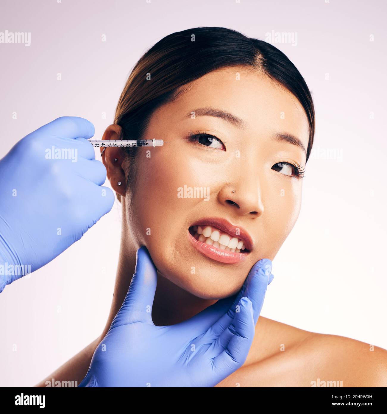 Face injection, skincare and Asian woman in pain in studio isolated on ...
