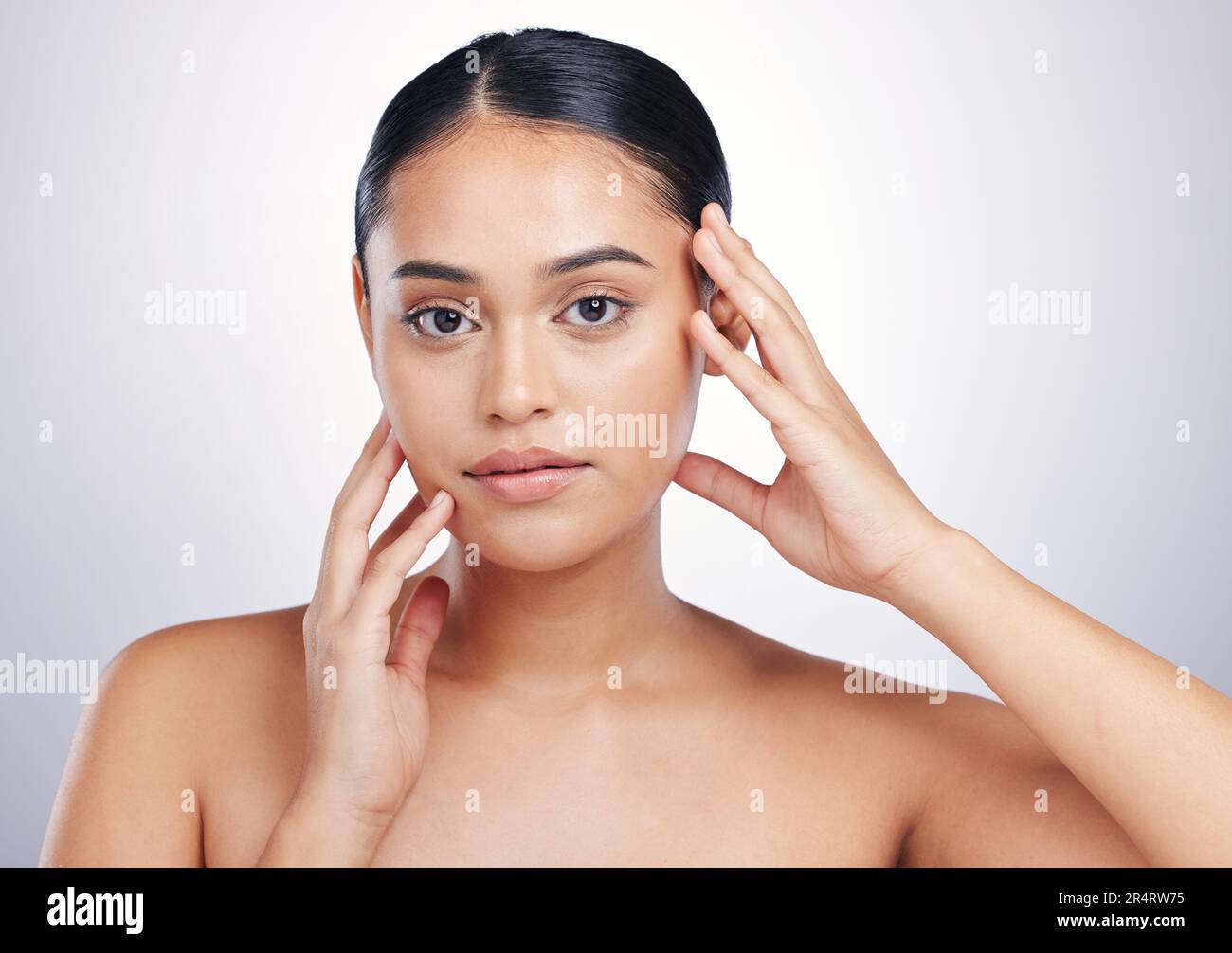 Beauty, skin and woman with hands on face in studio for glow ...