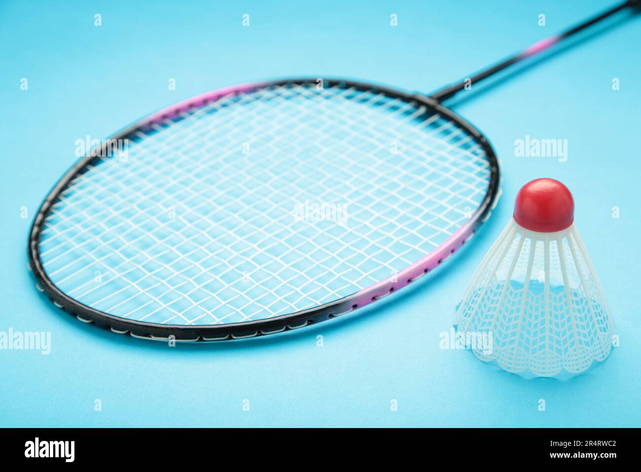 Shuttlecocks and badminton racket on blue background. Top view Stock ...