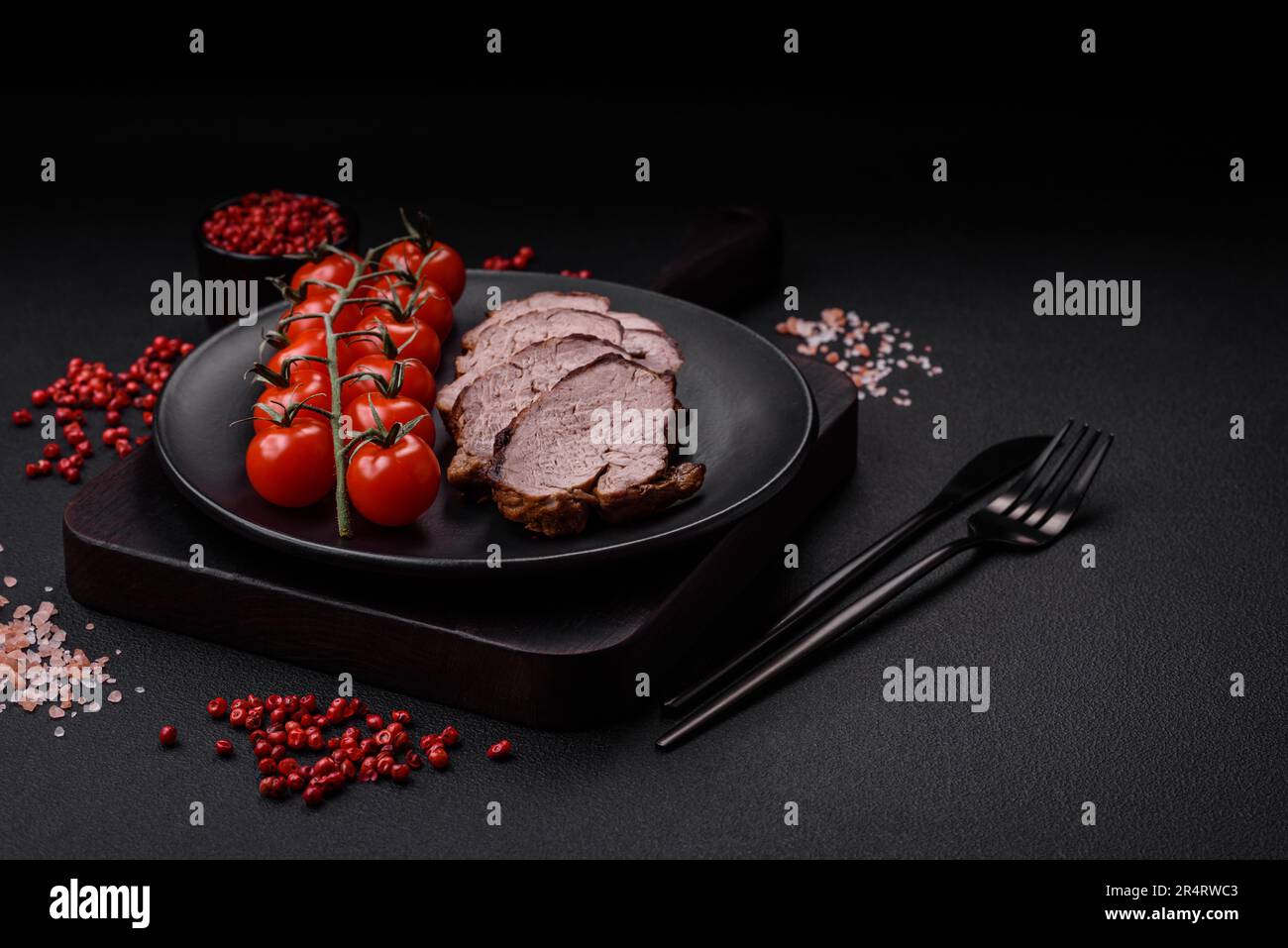 Delicious beef steak with salt, spices and herbs on a ceramic plate on ...