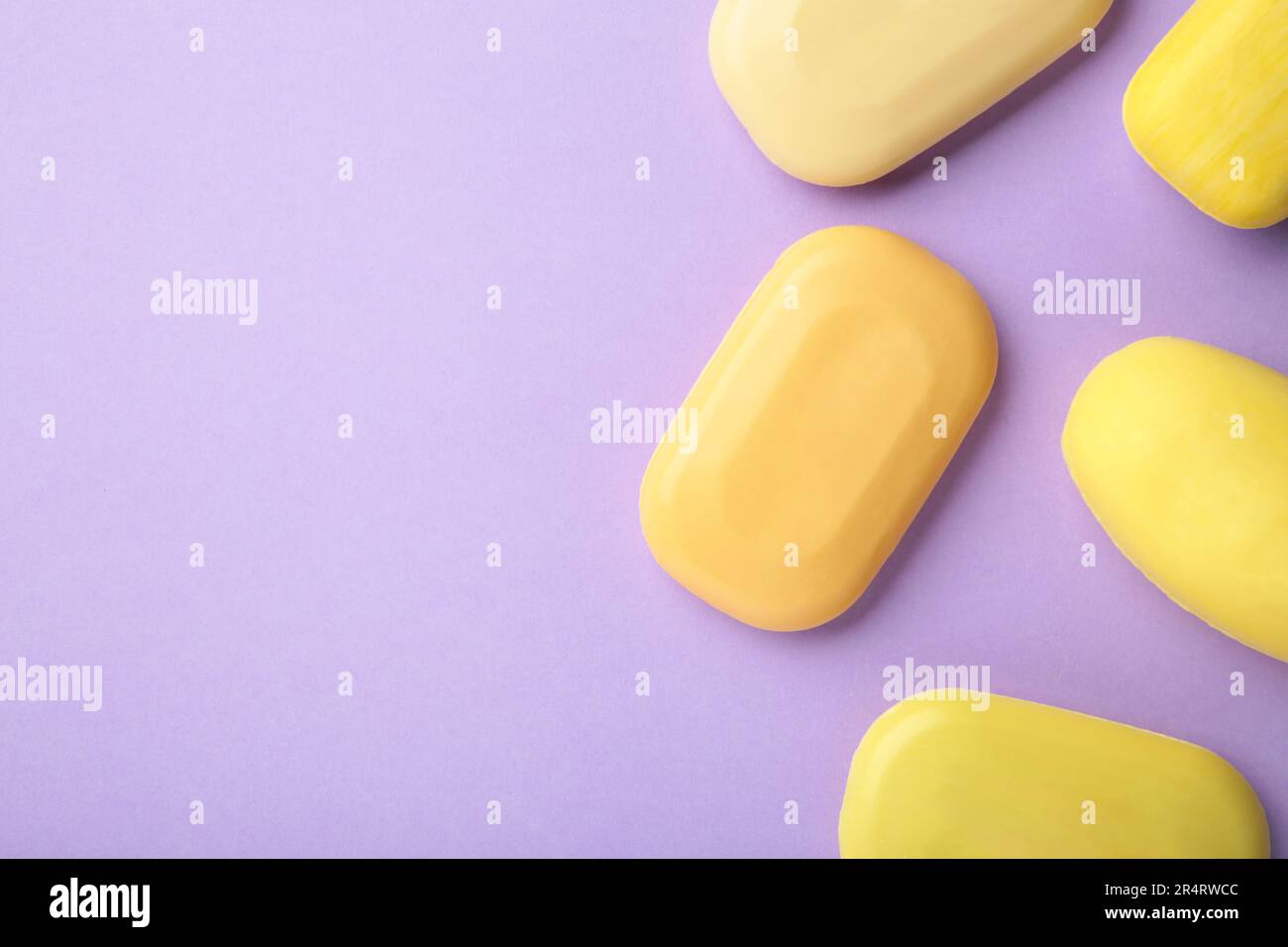 Different yellow soaps on purple . A lot of solid soap for hygiene and ...