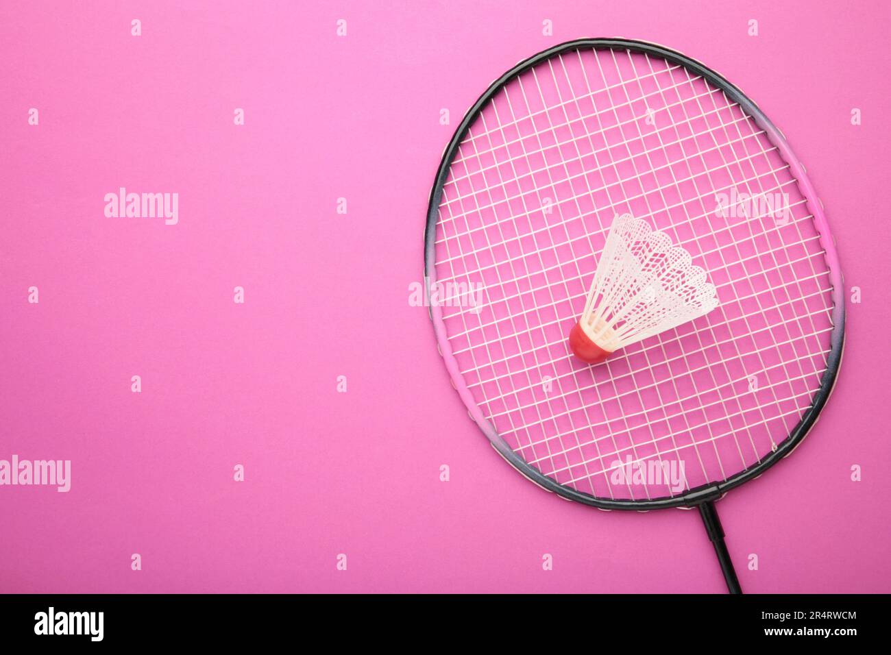 Shuttlecock and badminton racket on pink background. Top view Stock ...