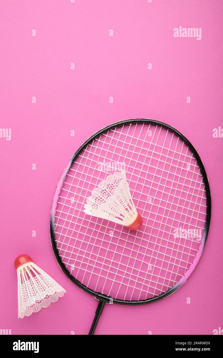 Shuttlecocks and badminton rackets on pink background. Top view Stock ...