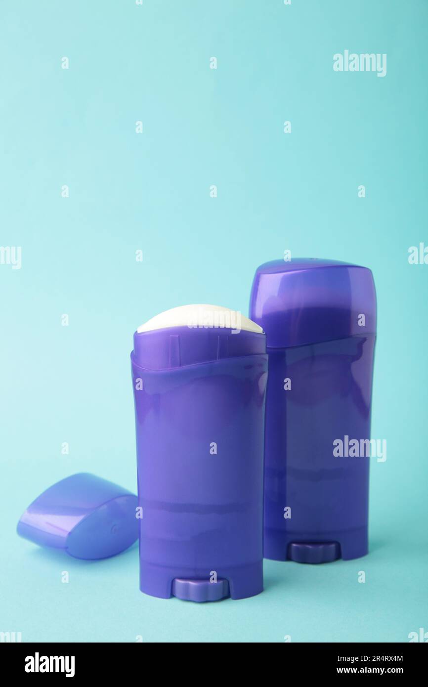 Violet antiperspirant deodorant on blue background. Skin care concept ...