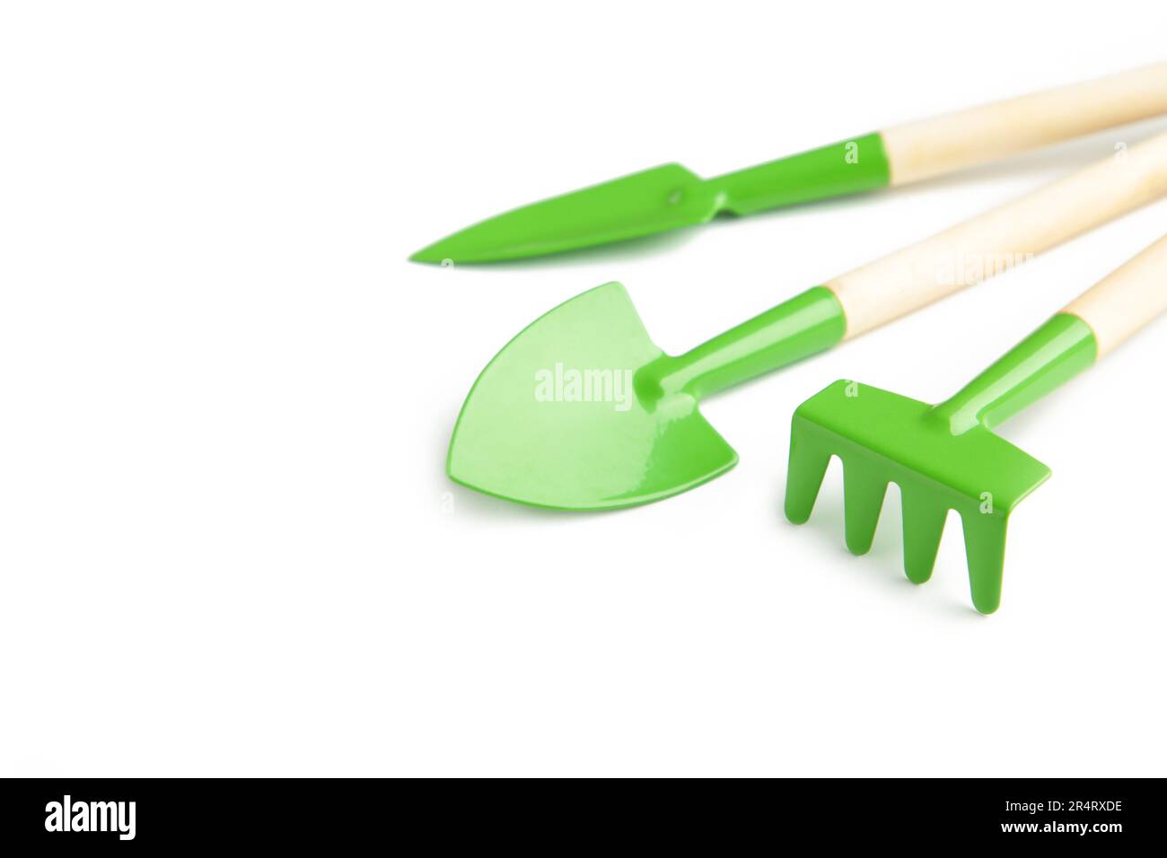 Green gardening tools isolated on white background. Close up. Top view ...