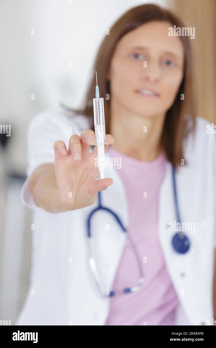 young doctor showing hand press syringe Stock Photo - Alamy