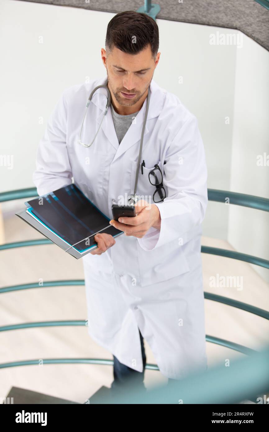 doctor talking by phone at hospital stairs Stock Photo - Alamy