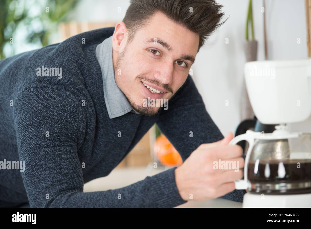 Young man making coffee home kitchen hi-res stock photography and ...