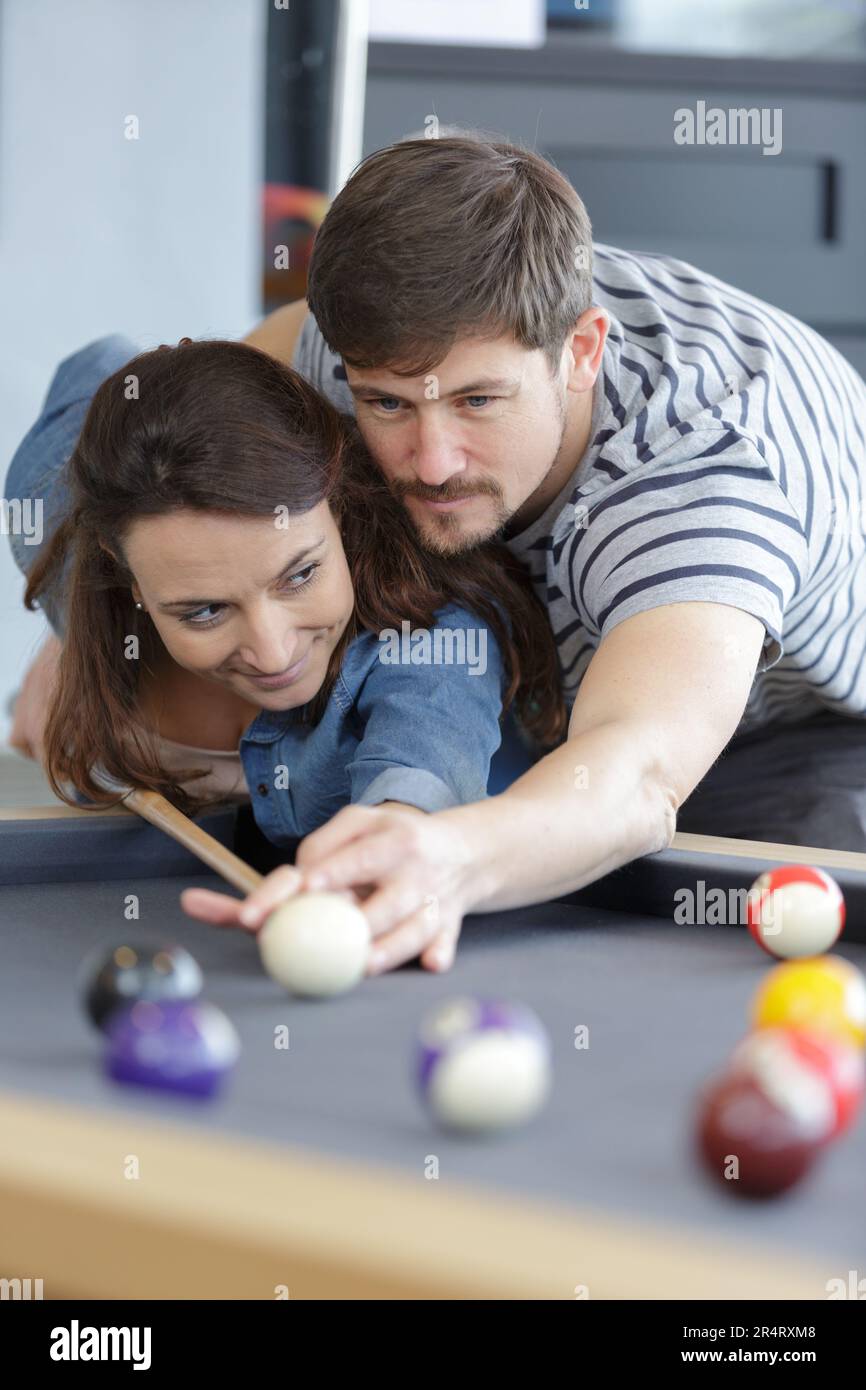 fashionable couple playing pool table billiards snooker Stock Photo - Alamy