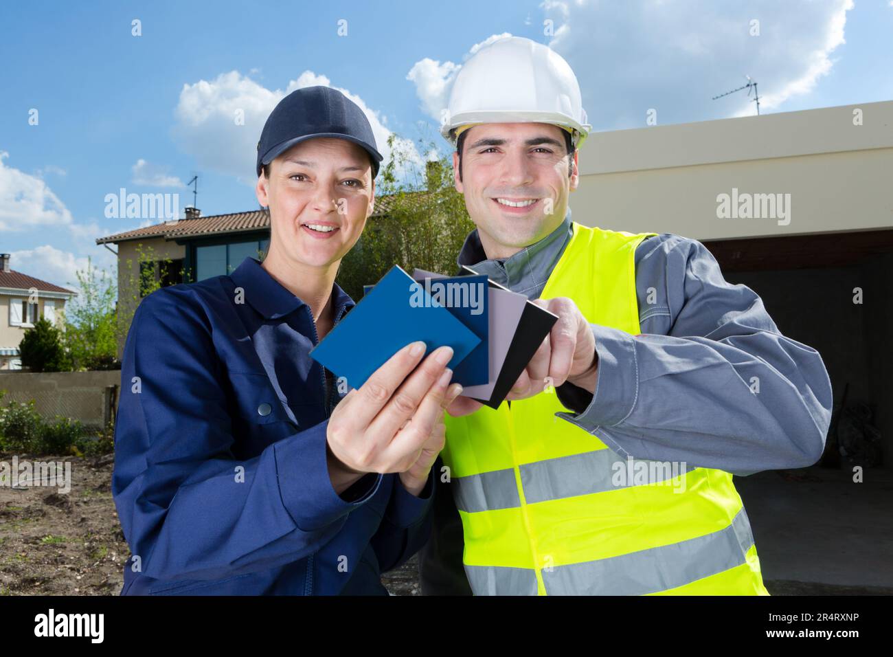 workers holding a color guide for exterior house paint Stock Photo - Alamy