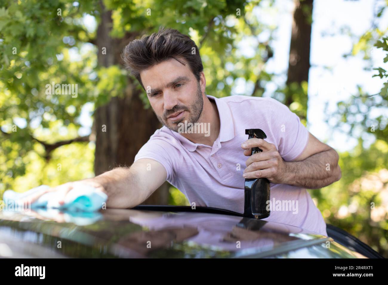 young man cleaning his car outdoors Stock Photo - Alamy
