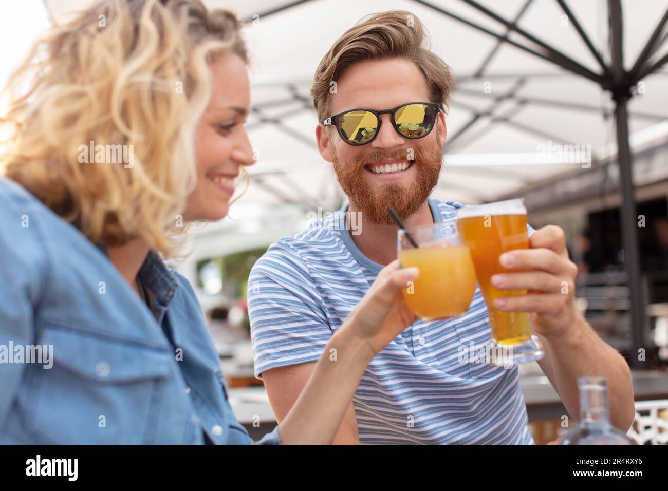 romantic couple drinking beer with artistic lens flare Stock Photo - Alamy