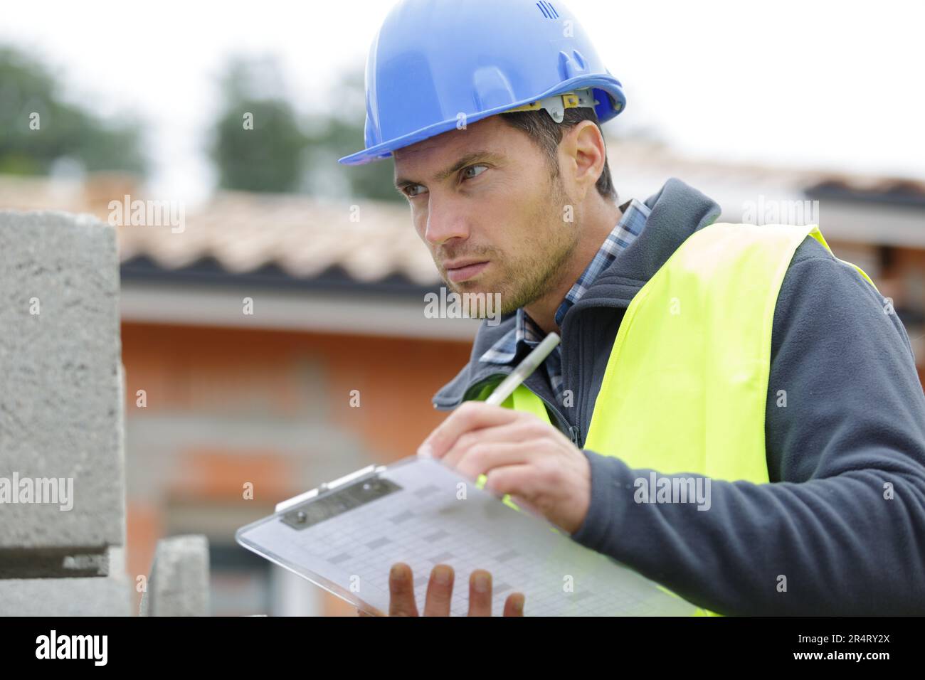 Construction worker check list hat hi-res stock photography and images ...
