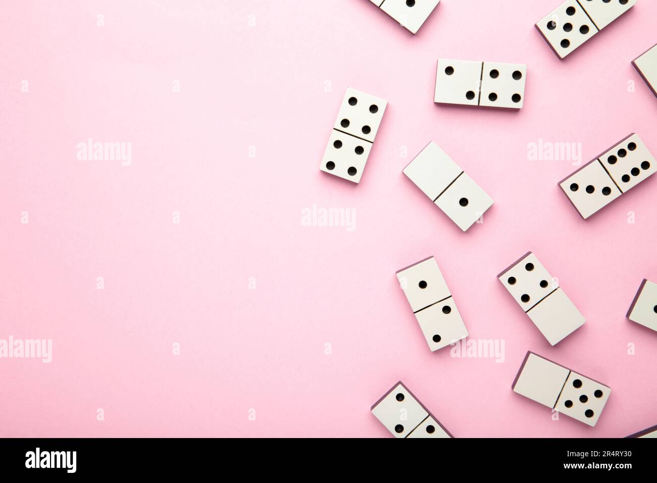 Domino pieces on the pink background. Top view Stock Photo - Alamy
