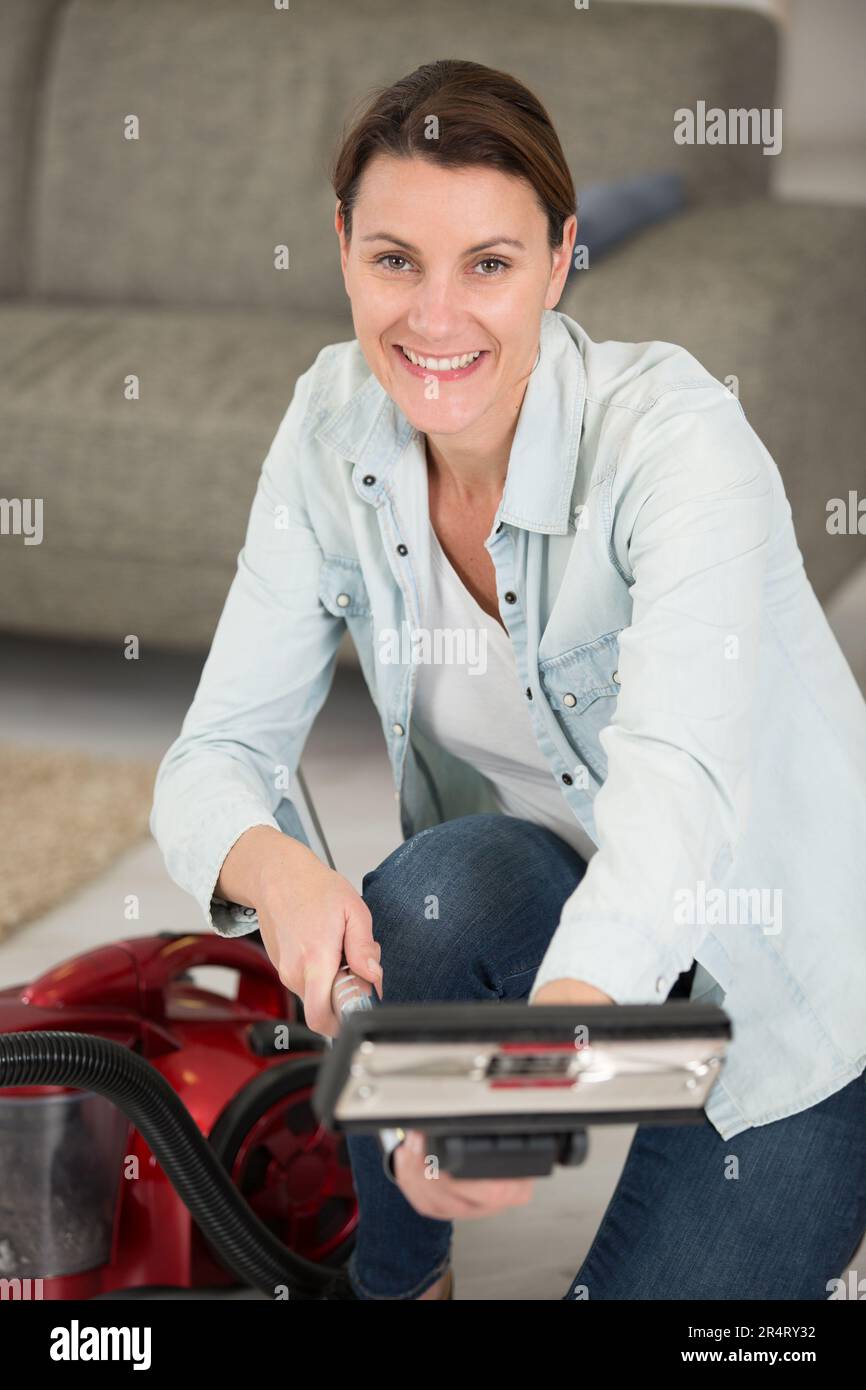 Hoovering woman smile hi-res stock photography and images - Alamy
