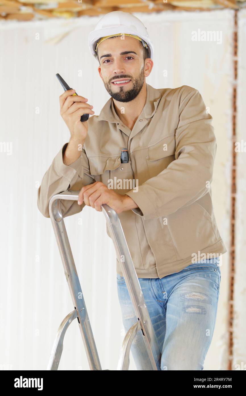 a male builder on ladder Stock Photo - Alamy