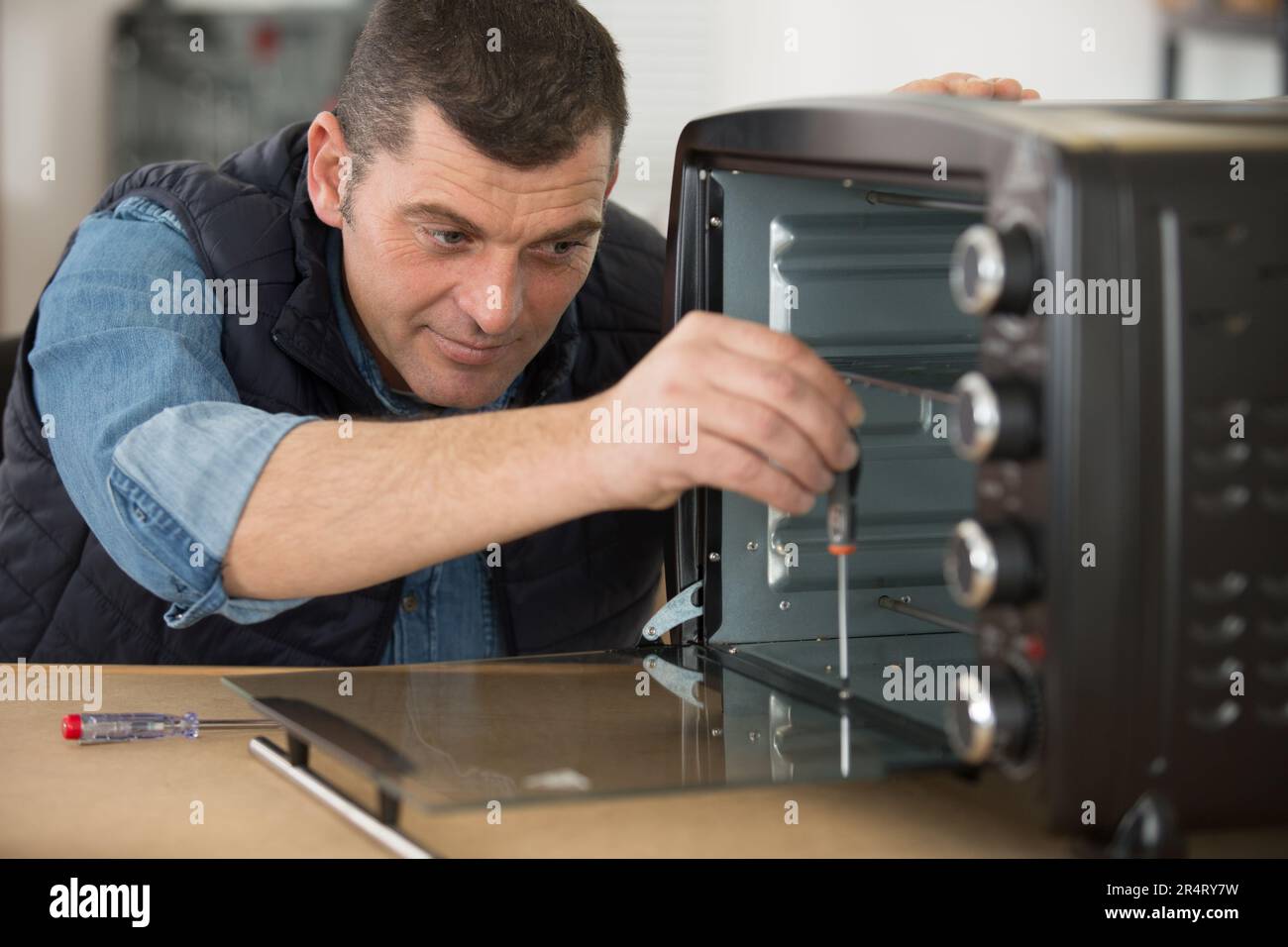 Checking oven hi-res stock photography and images - Alamy