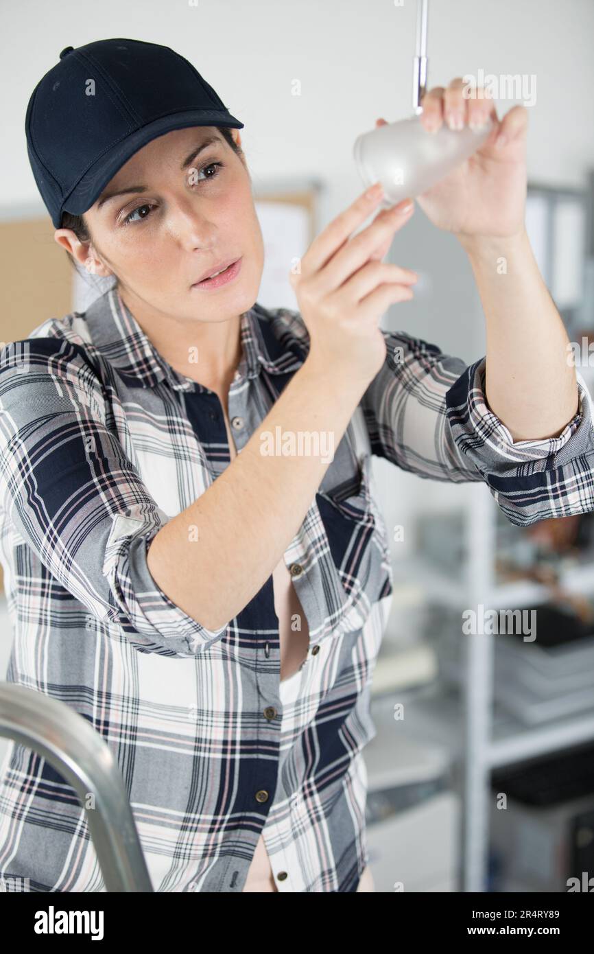 woman replacing light bulb at home Stock Photo - Alamy
