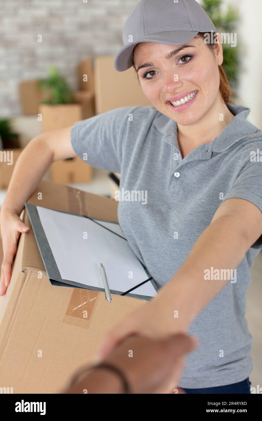 portrait of delivery woman giving order boxes Stock Photo - Alamy