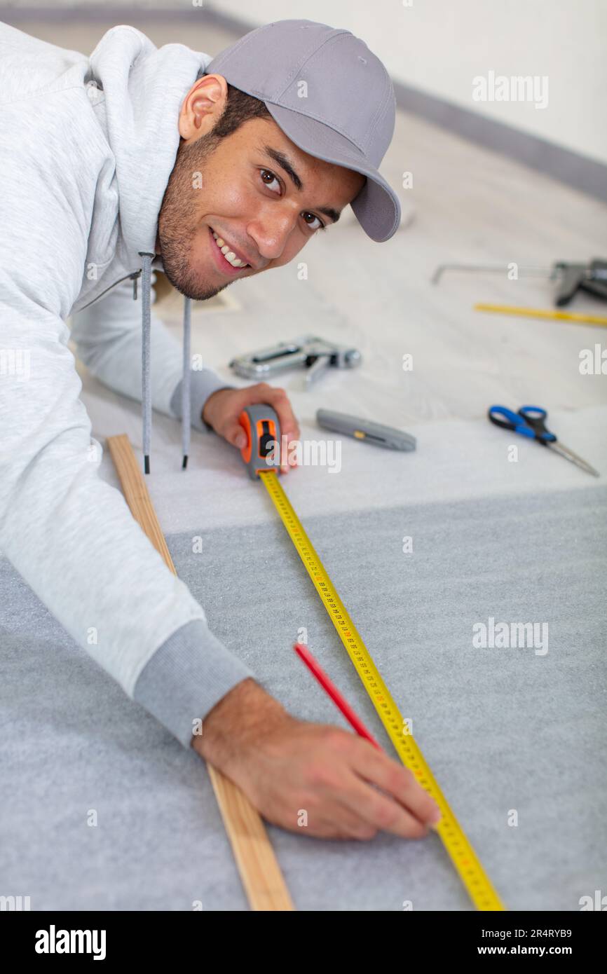 builder measuring floor indoors at site Stock Photo - Alamy