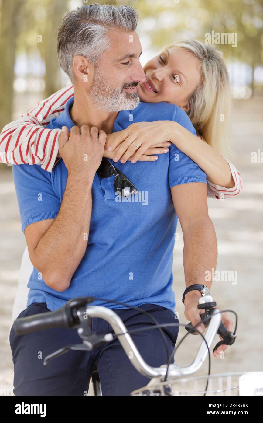 couple hugging near the modern bicycle in park Stock Photo - Alamy