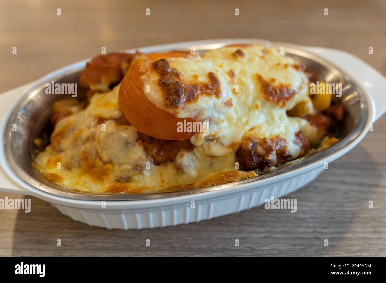 Cheese baked rice with pork chop and tomato Stock Photo - Alamy