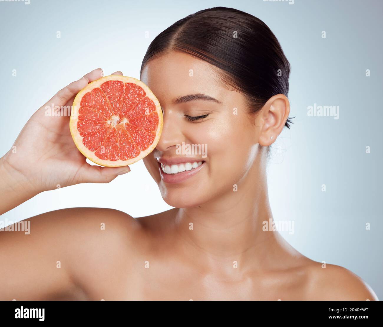 Face smile, skincare and woman with grapefruit in studio isolated on a ...